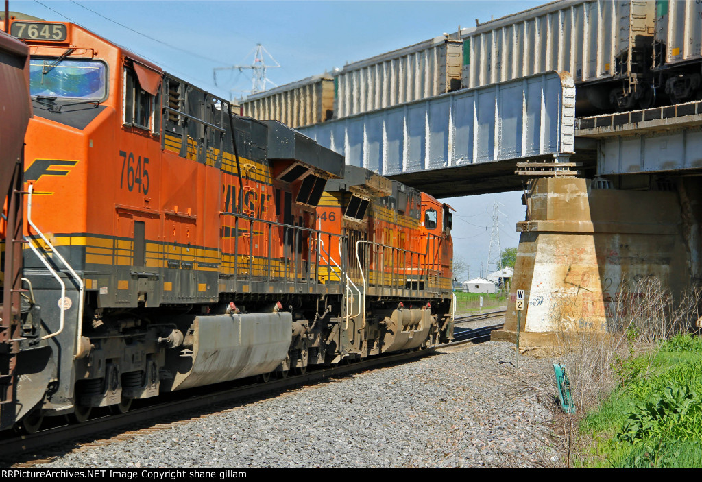 BNSF 4446 Runs EB with a grain train While a Wb grain passes over head.